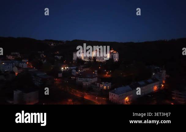 An aerial view of the spa town of Karlovy Vary illuminated at dusk and ...