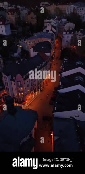 An aerial view of the spa town of Karlovy Vary illuminated at dusk and ...