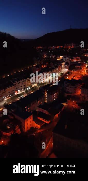An aerial view of the spa town of Karlovy Vary illuminated at dusk and ...