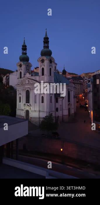 An aerial view of the spa town of Karlovy Vary illuminated at dusk and ...