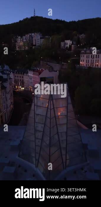 An aerial view of the spa town of Karlovy Vary illuminated at dusk and ...