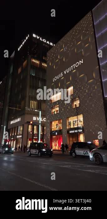 GINZA, JAPAN - MARCH 2, 2026: Illuminated luxury fashion boutiques and ...
