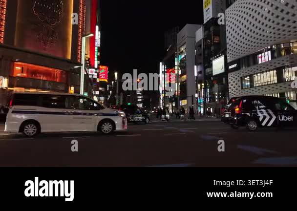 GINZA, JAPAN - MARCH 2, 2026: Illuminated luxury fashion boutiques and ...
