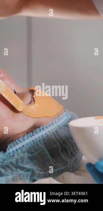 Close up of a person who visiting the beauty salon, fruit mask is ...