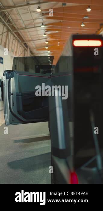 An electric vehicle is parked at a charging station in a busy urban ...