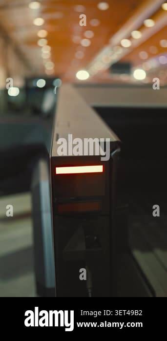A view shows a sleek checkout machine in a store. The device has bright ...