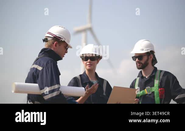 A professional Windmill engineer inspects and discusses operations at a ...