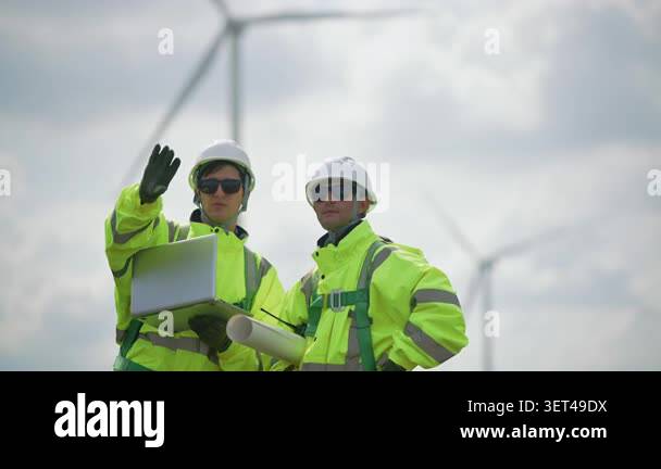 A professional Windmill engineer inspects and discusses operations at a ...