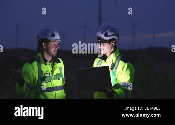 A professional Windmill engineer inspects and discusses operations at a ...