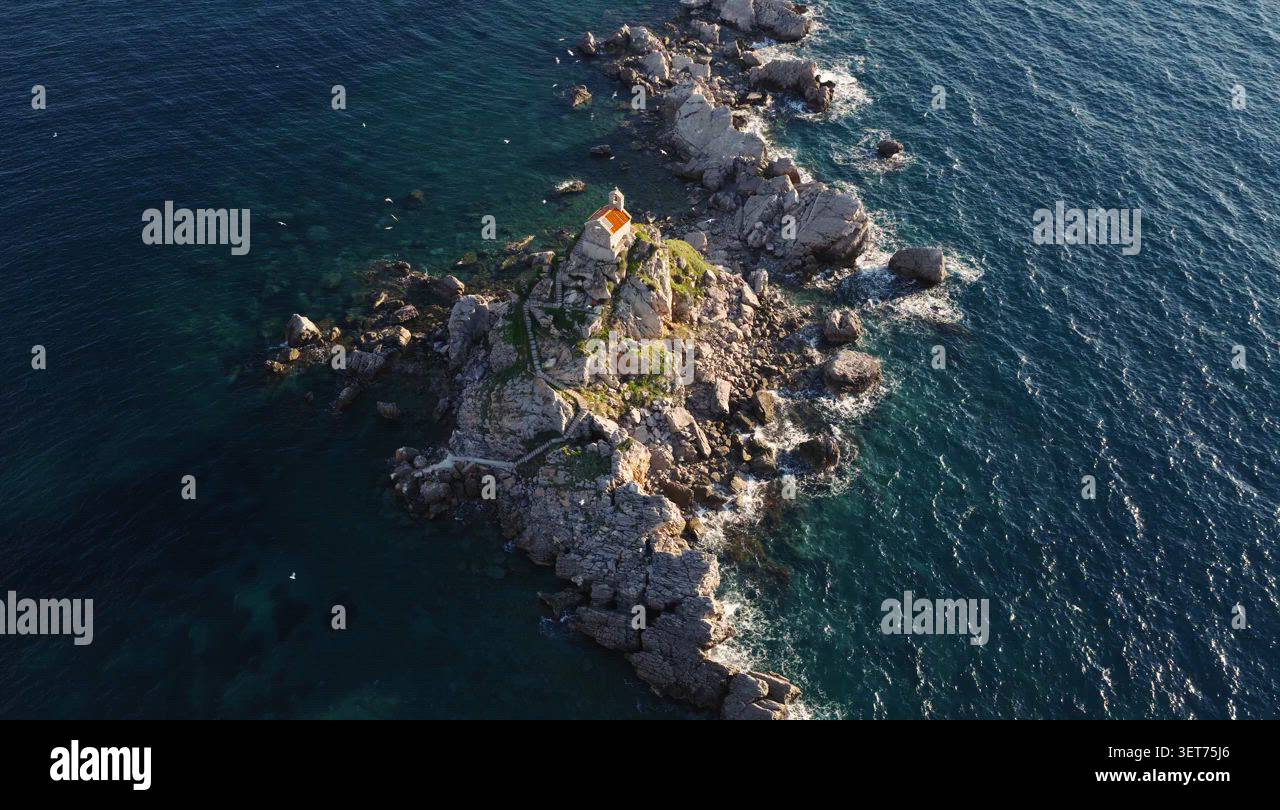 Small church Sits on Rocky Island in the sea, flock of seagulls Stock ...