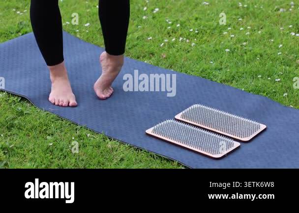 Woman stepping onto sadhu board during acupressure practice Stock Video ...