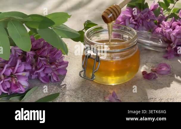 Fresh golden honey dripping from honey dipper Stock Video Footage - Alamy
