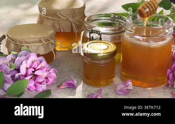 Fresh golden honey dripping from honey dipper Stock Video Footage - Alamy
