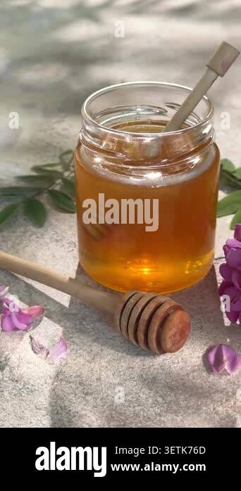 Fresh golden honey dripping from honey dipper Stock Video Footage - Alamy