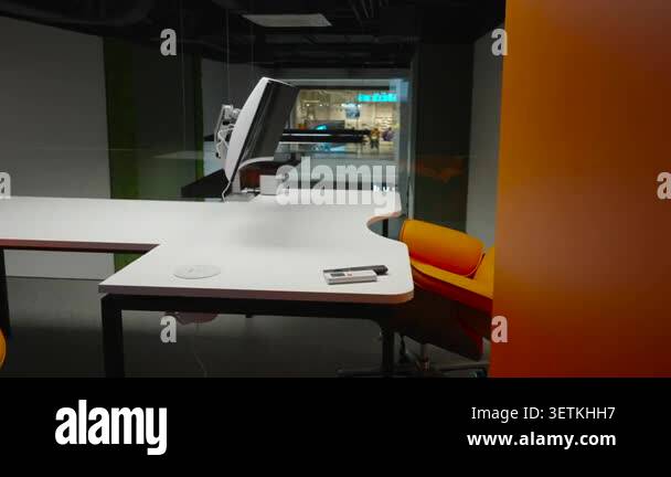 Modern commercial interior with a white desk, computer monitor, and ...