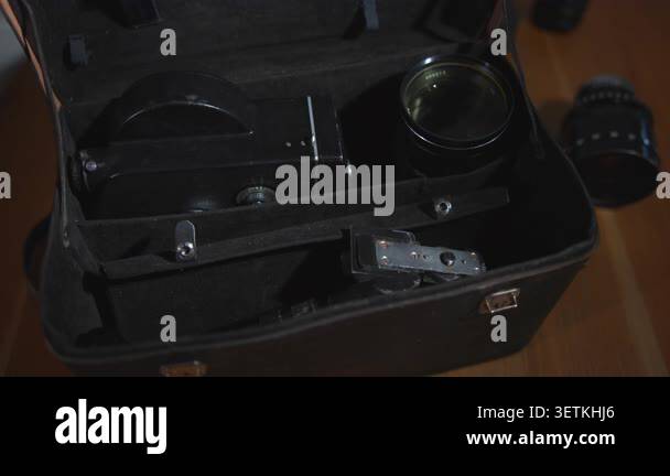 Close-up top view of an open black carrying case holding a vintage ...
