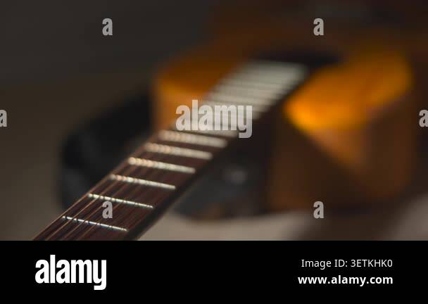 Diagonal close-up of a guitar fretboard in sharp focus with the ...