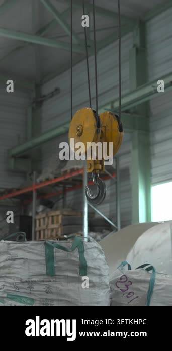 Yellow Hoist Lifting Large Bulk Bag Overhead, Visible Cable And Pulley ...
