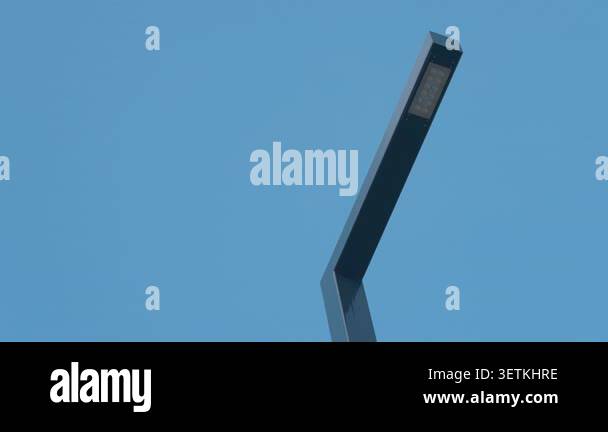 A modern streetlight shifts through an early to late sequence, moving ...