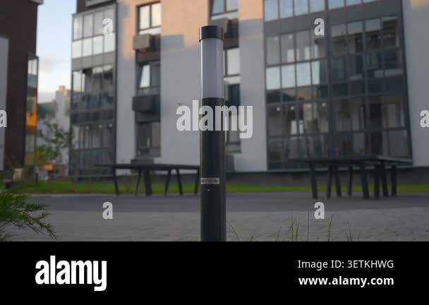 A calm time sequence in a modern residential courtyard, with a dark ...