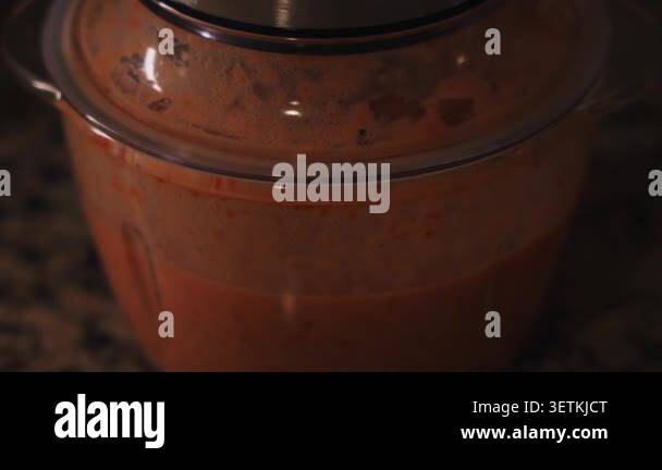 Tomato mixture blending in food processor for gazpacho recipe close up ...