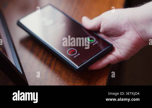 Hand hesitating to answer scam call alert on smartphone screen closeup ...
