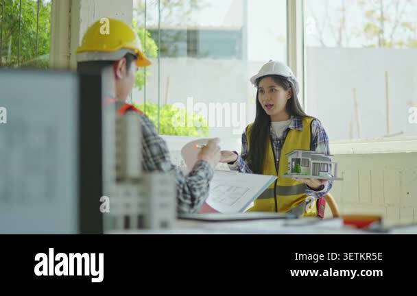 Two construction workers discussing project plans in office Stock Video ...