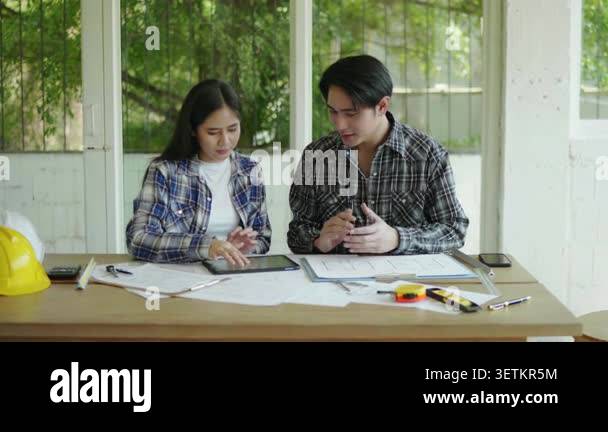 Two architects discussing ideas while using tablet in office Stock ...