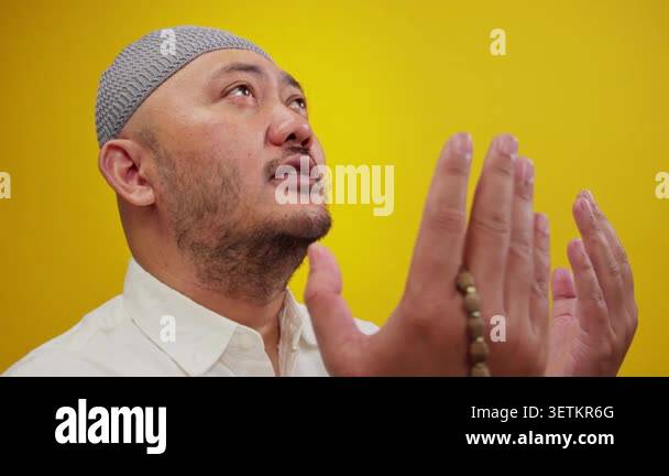 Close-Up of a Muslim Man Holding Tasbih While Praying Sincerely ...
