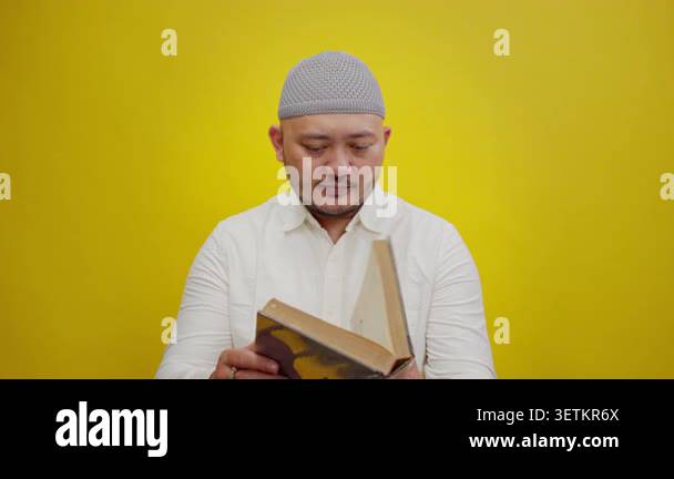 Muslim Man Respectfully Closing the Holy Quran and Touching It to His ...