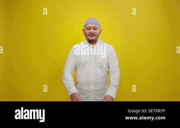 Man in a White Shirt Making a Respectful Greeting with Hands Together ...