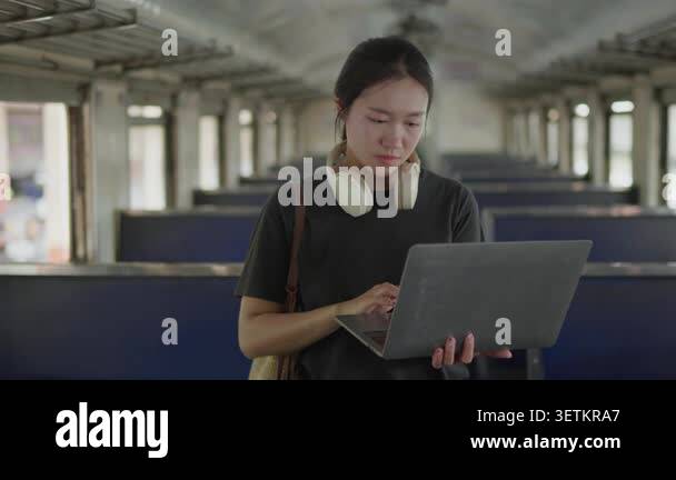 Woman using laptop while sitting inside train Stock Video Footage - Alamy