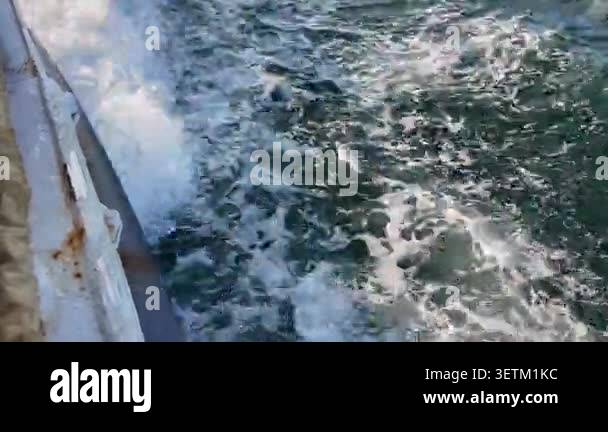 Close up abstract shot of turquoise ocean waves rolling and churning ...