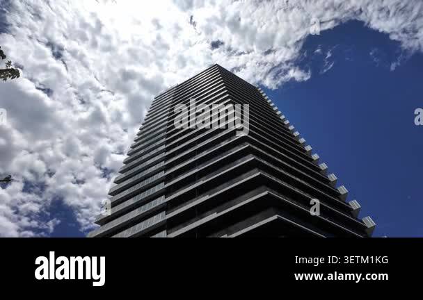 Low angle view of a modern skyscraper building against a dramatic ...