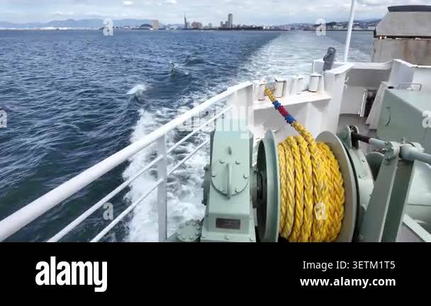 Onboard view of a passenger ferry cruising in the sea, showing a rope ...