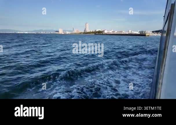 Side view from a passenger ferry looking out at the deep blue ocean ...