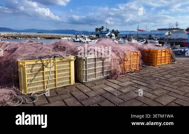 Close up of commercial fishing nets and equipment on the dock with a ...