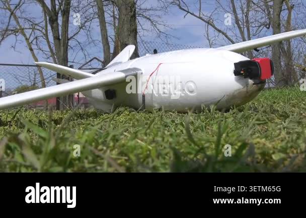 Medium-range aircraft-type strike drone resting on grass before launch ...