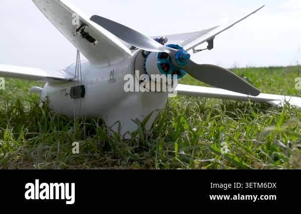 Medium-range aircraft-type strike drone resting on grass before launch ...