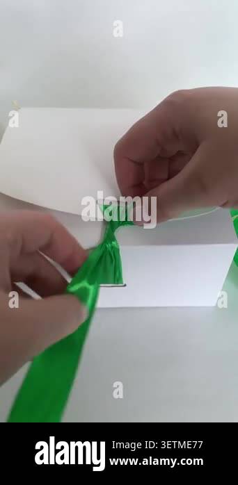 Artisan Tying Bright Green Satin Ribbon on White Gift Box Final ...
