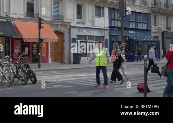 PARIS, FRANCE, JUNE 4, 2026 A school crossing guard in a high ...