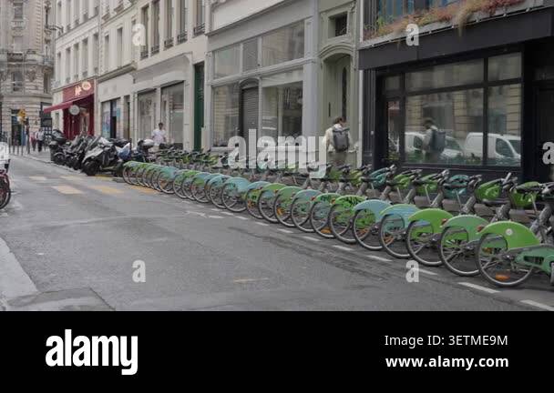 PARIS, FRANCE, JUNE 4, 2026 Mechanical and electric sharing bicycles ...