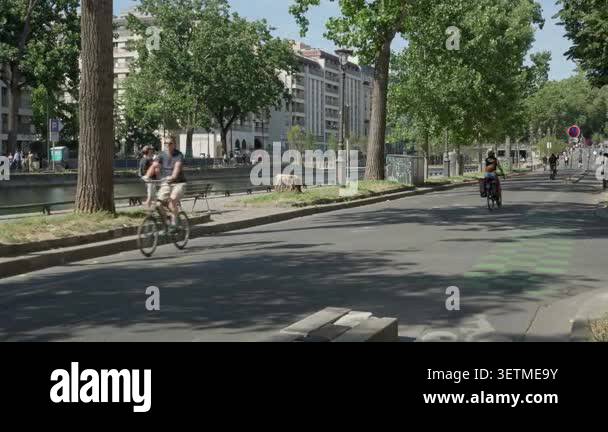 PARIS, FRANCE, JUNE 4, 2026 People ride bicycles and electric scooters ...