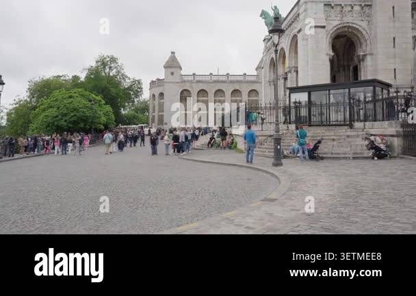 PARIS, FRANCE, JUNE 4, 2026 Tourists walk on cobblestone square by ...