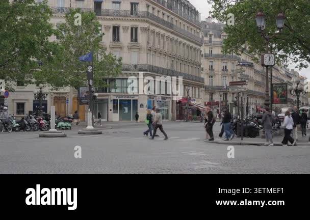 PARIS, FRANCE, JUNE 4, 2026 A group of pedestrians walks across a ...