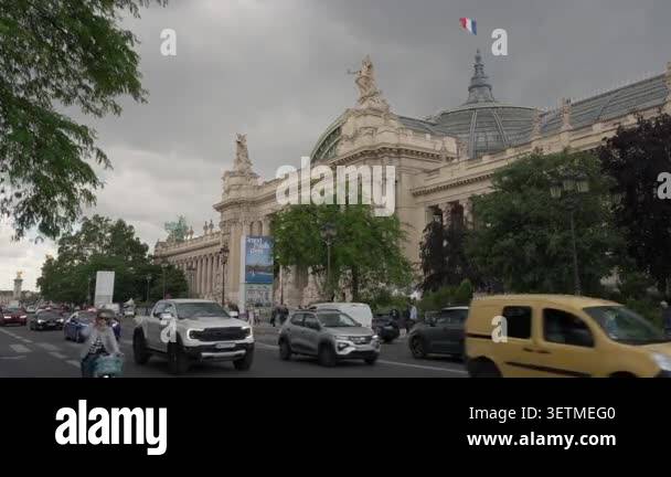PARIS, FRANCE, JUNE 4, 2026 Vehicles and a cyclist transit past the ...