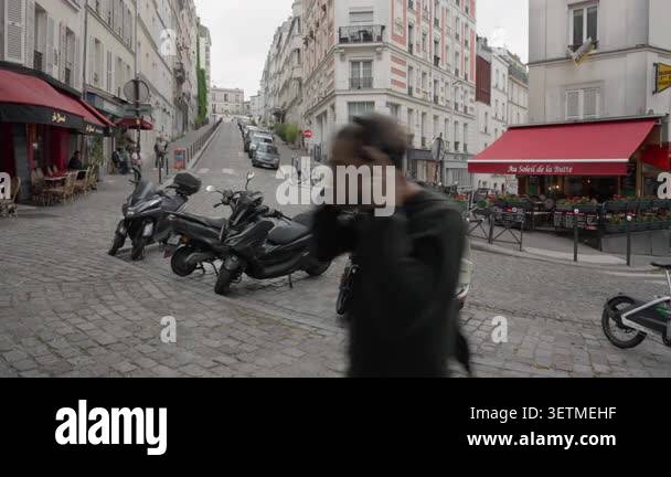 PARIS, FRANCE, JUNE 4, 2026 Scooters and electric bikes parked on a ...