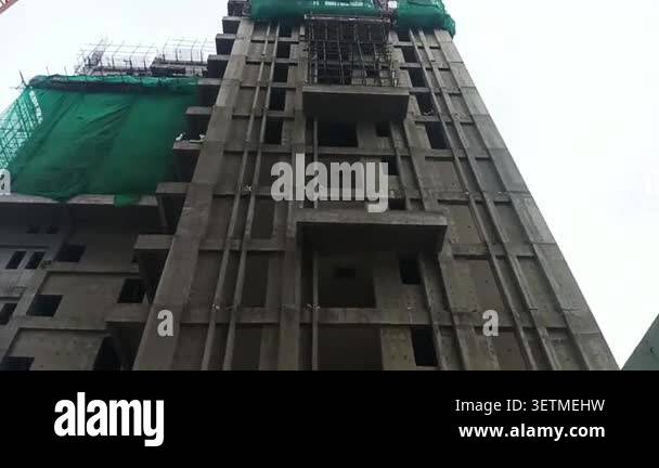 An editorial view of a high-rise building under construction with a ...