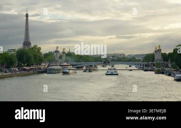A wide panorama of cruise boats navigating the Seine River near the ...