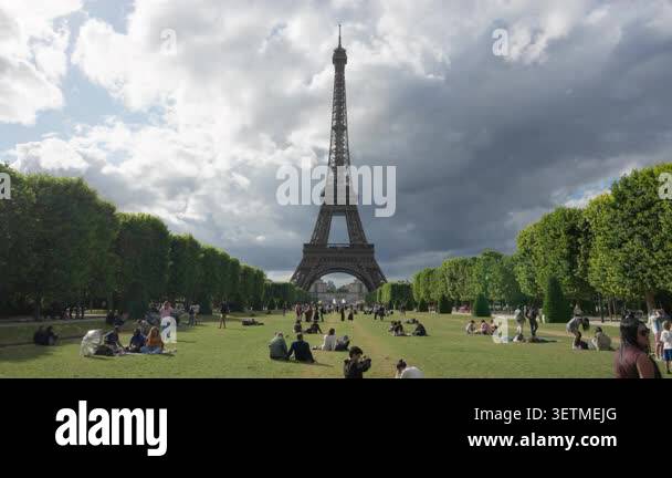 PARIS, FRANCE, JUNE 4, 2026 Crowds of tourists relax on Champ de Mars ...